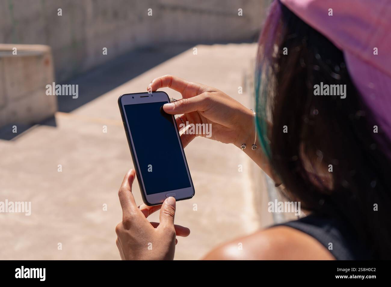 A smiling millennial woman checking her cell phone messages Stock Photo ...