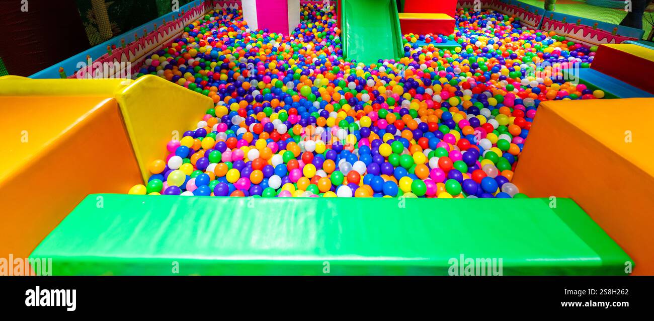 Spacious ball pit with colorful spheres and soft play structures for ...