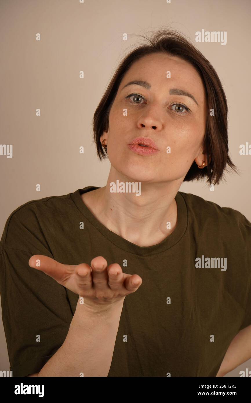 Feminine woman sending air kiss at camera, coquettish flirty pose ...