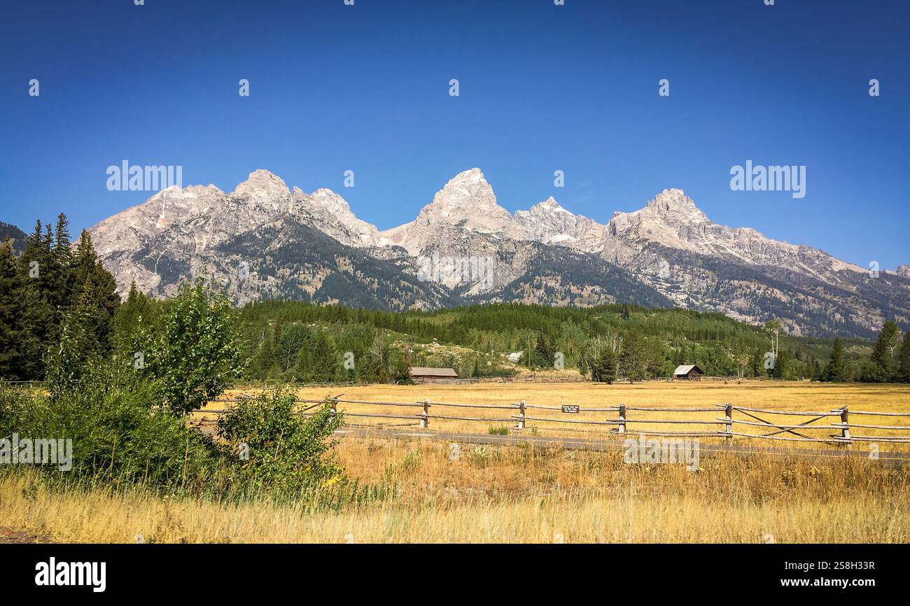 Panorama of Wood Fence and Cabins Beneath Peaks of Grand Teton National ...