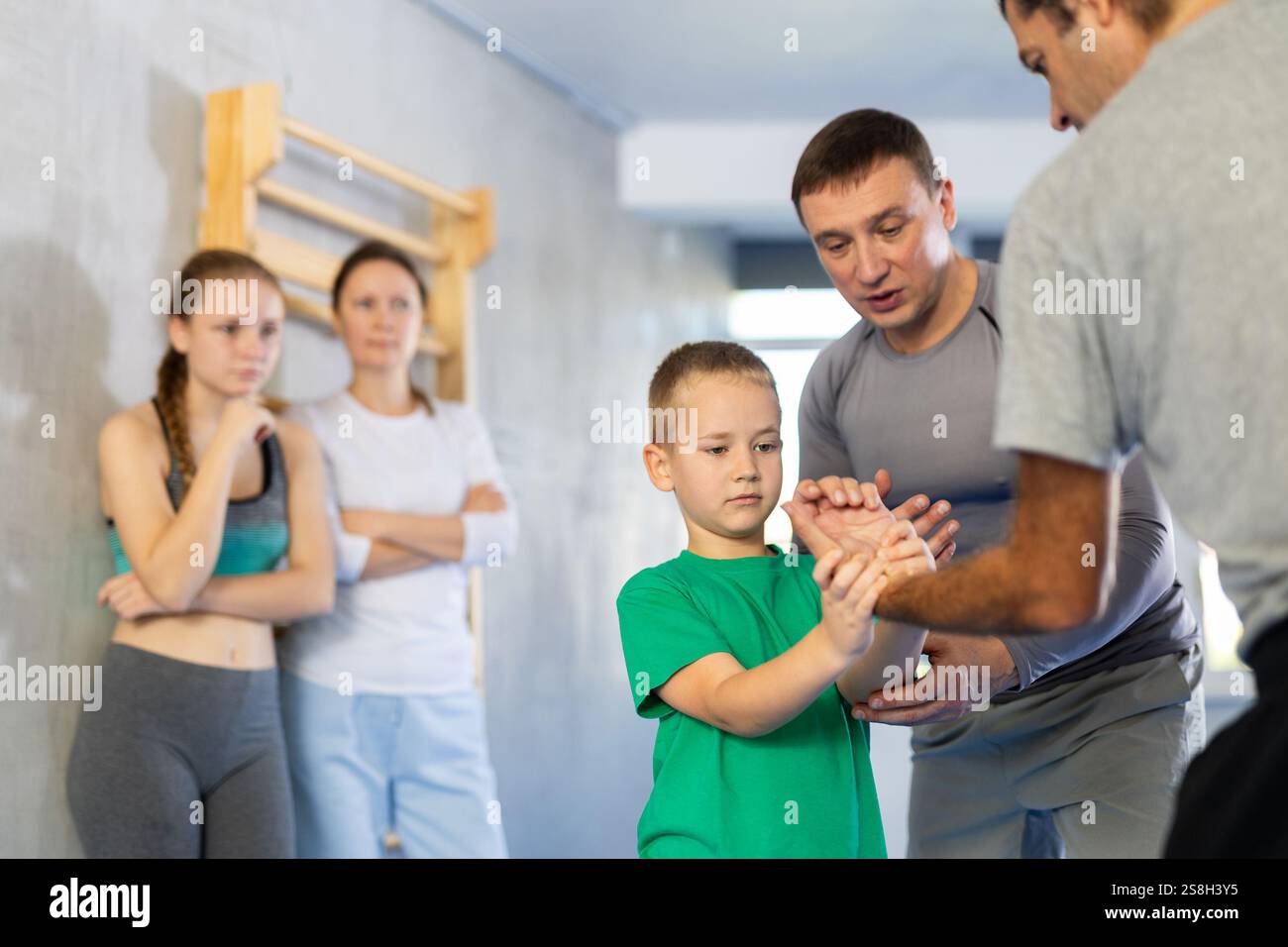 Trainer at self-defense training teaches students technique of grabbing ...