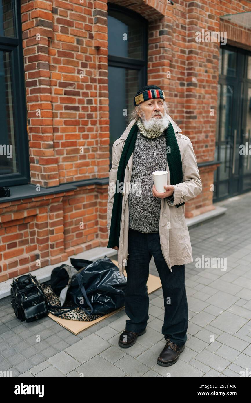 Full length vertical portrait of mature adult homeless man with lengthy ...