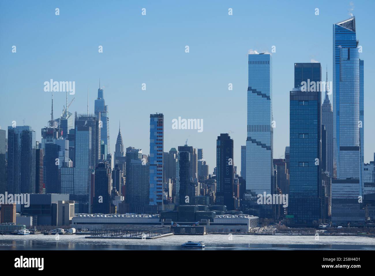 Boats make their way through icy waters around the edges of Manhattan ...