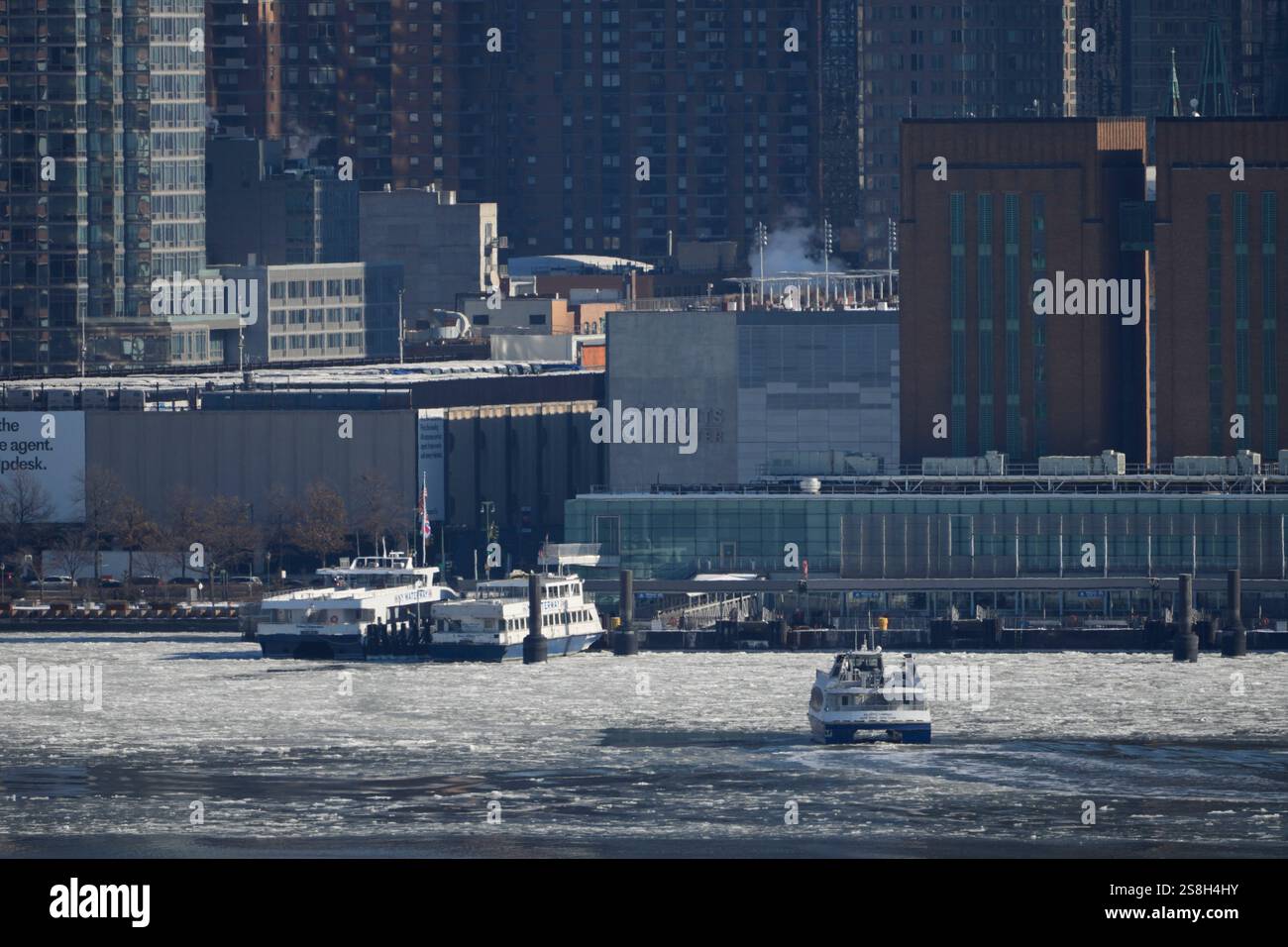 Boats make their way through icy waters around the edges of Manhattan ...