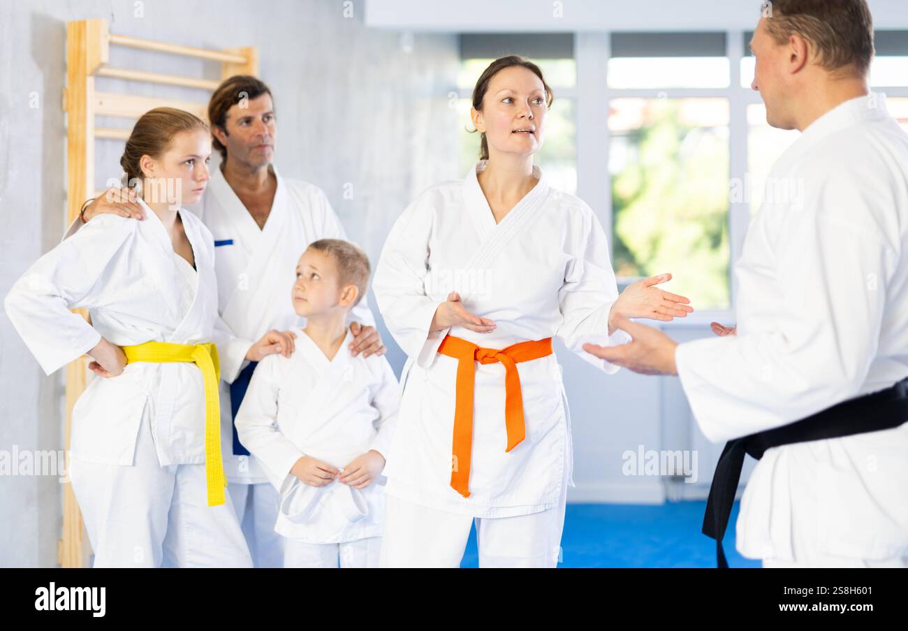 After completing family session and karate training, parents talk with ...