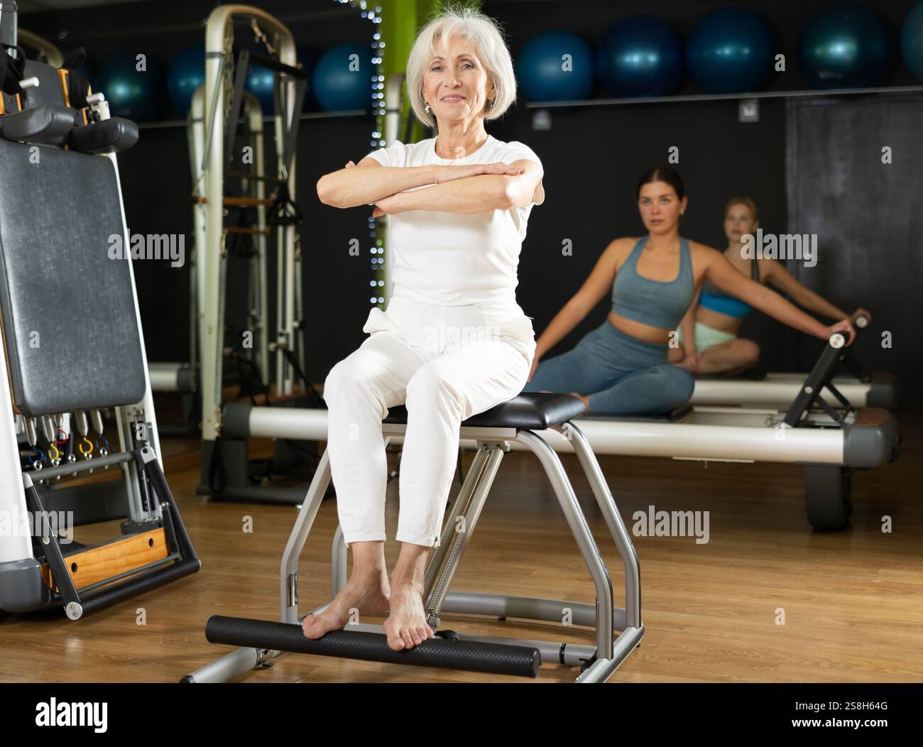 Mature woman doing exercises on a Pilates chair Stock Photo - Alamy