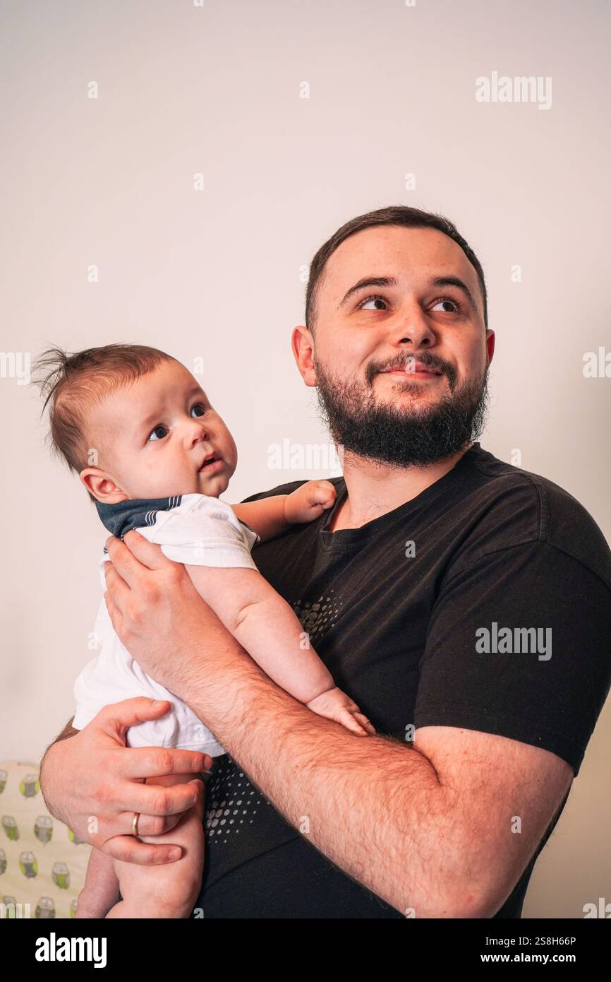 The father's eyes sparkle with joy as he watches his son, his ...