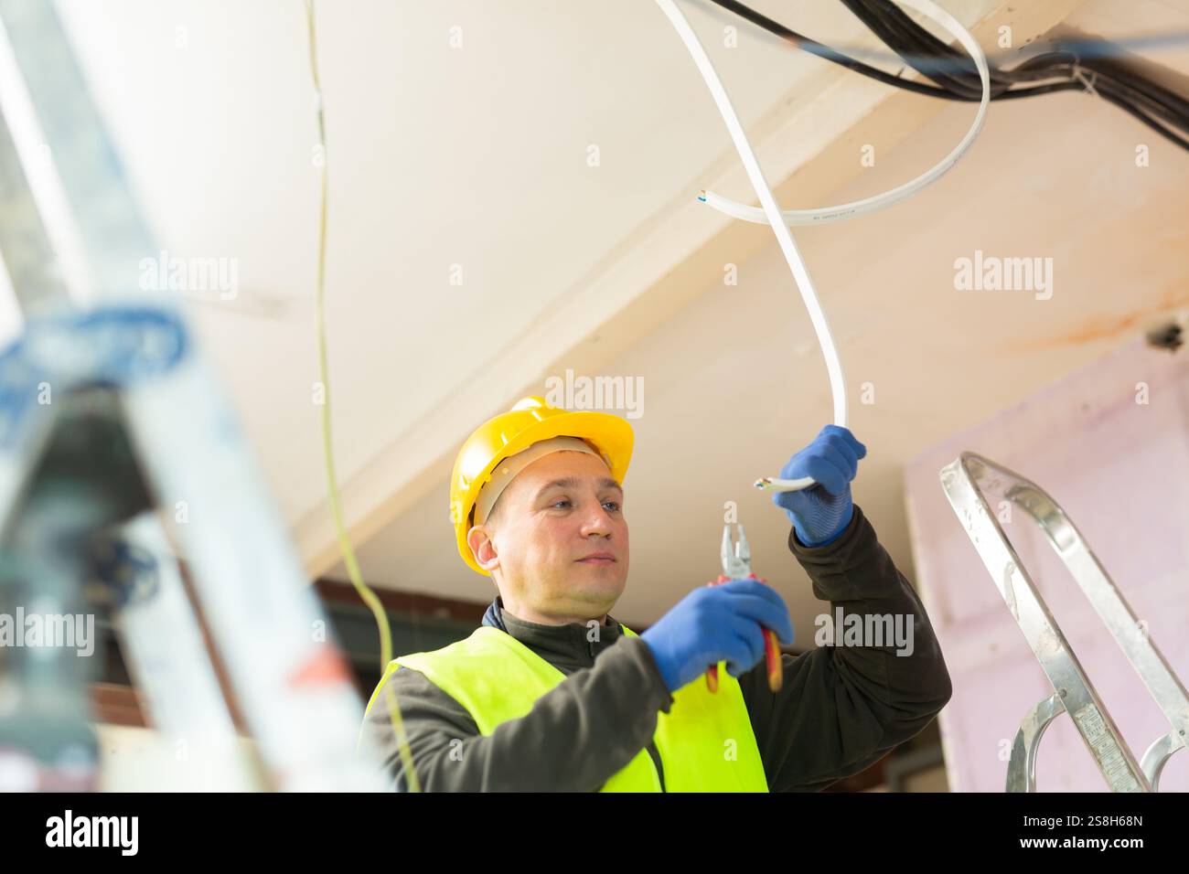 Electrician working with wires in apartment Stock Photo - Alamy