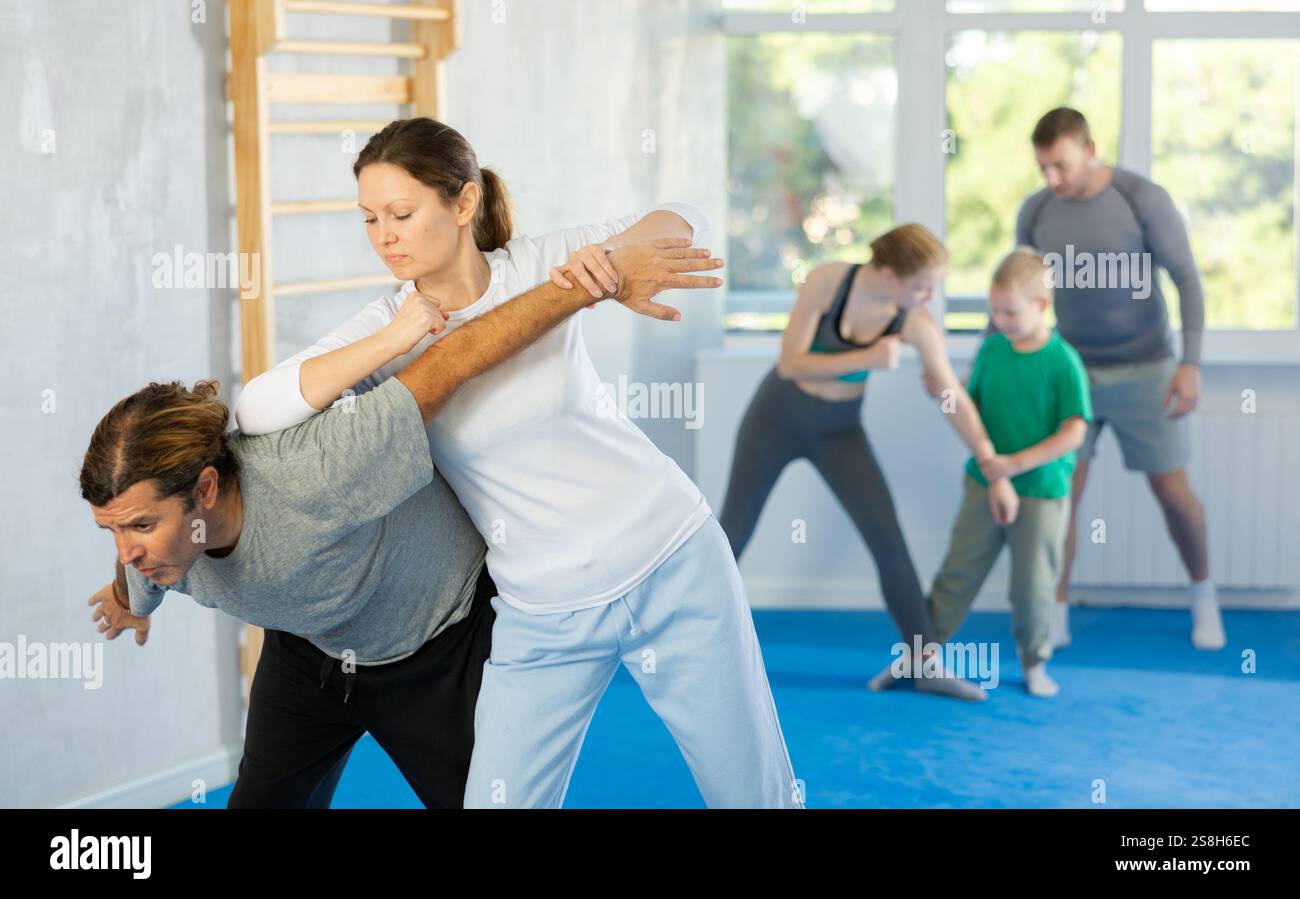 Woman in gym perform basic elements of krav maga self-defense system ...