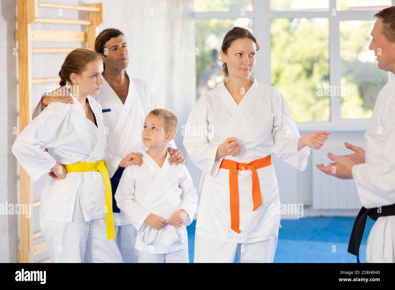 After completing family session and karate training, parents talk with ...