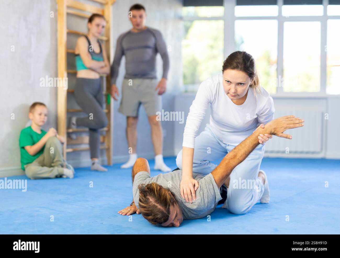 Woman in gym perform basic elements of krav maga self-defense system ...