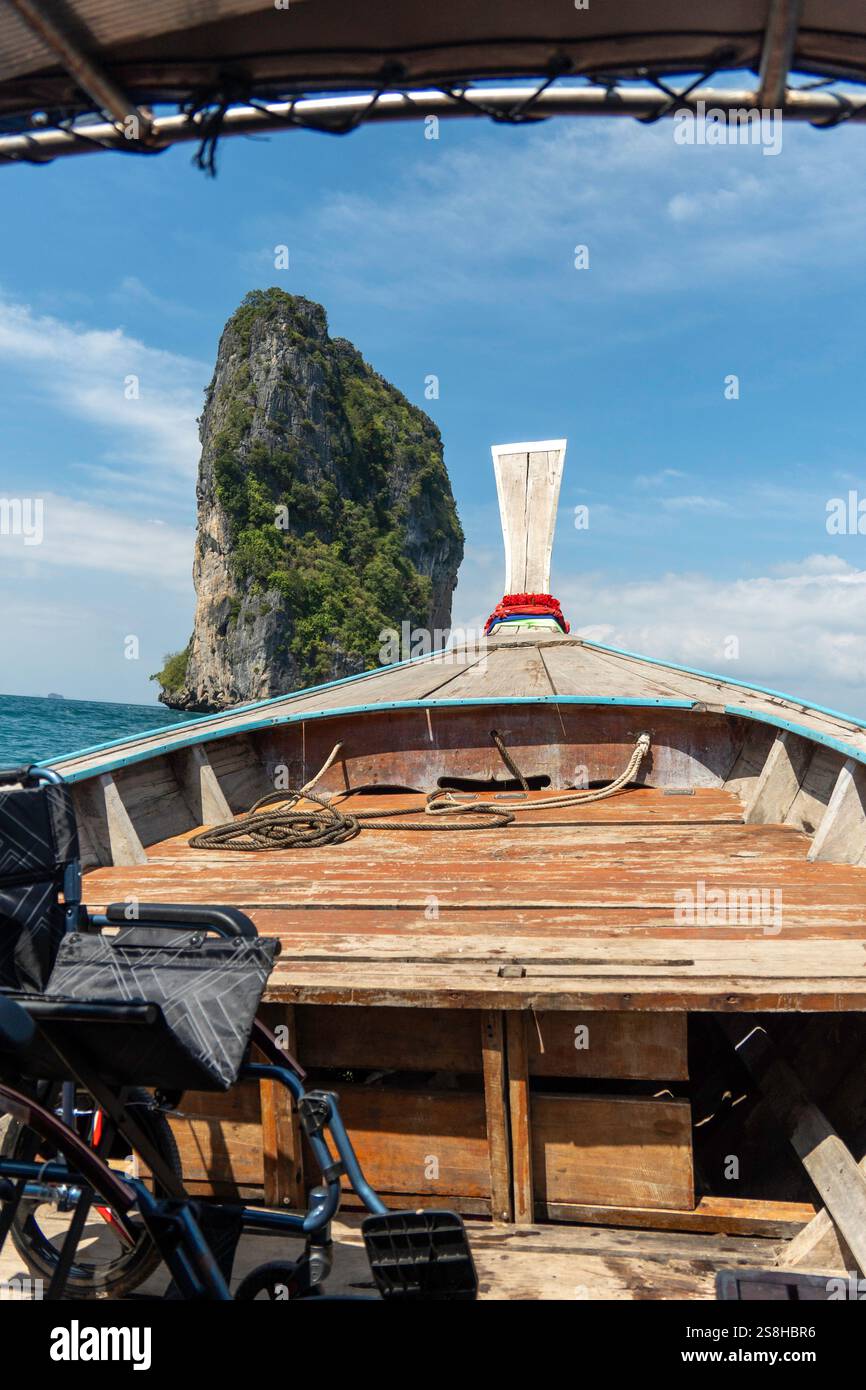Scenic boat ride under towering limestone cliffs in Thailand's stunning ...