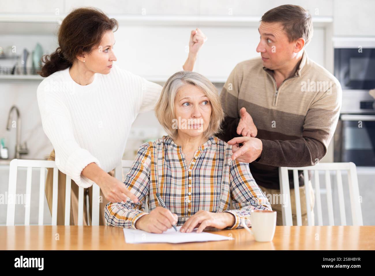 Old woman signing papers Stock Photo - Alamy