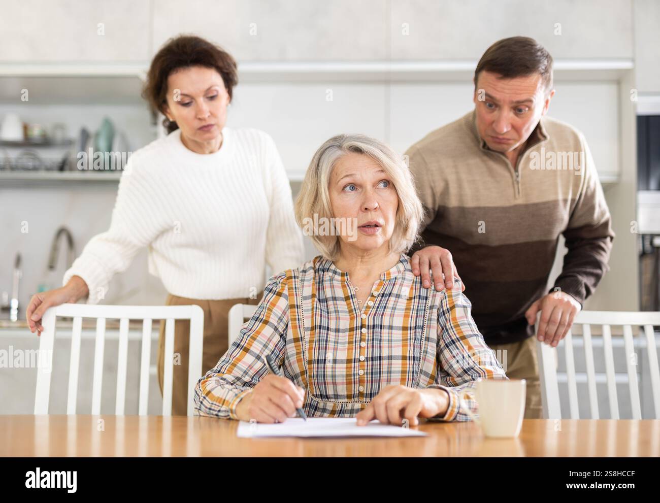 Old woman signing papers Stock Photo - Alamy