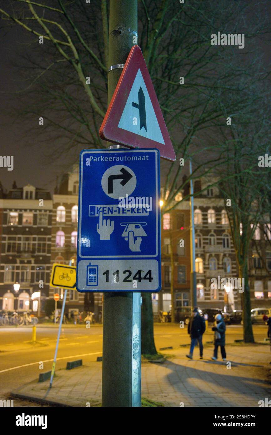 Traffic sign indicating location of parking meter and instruction that ...