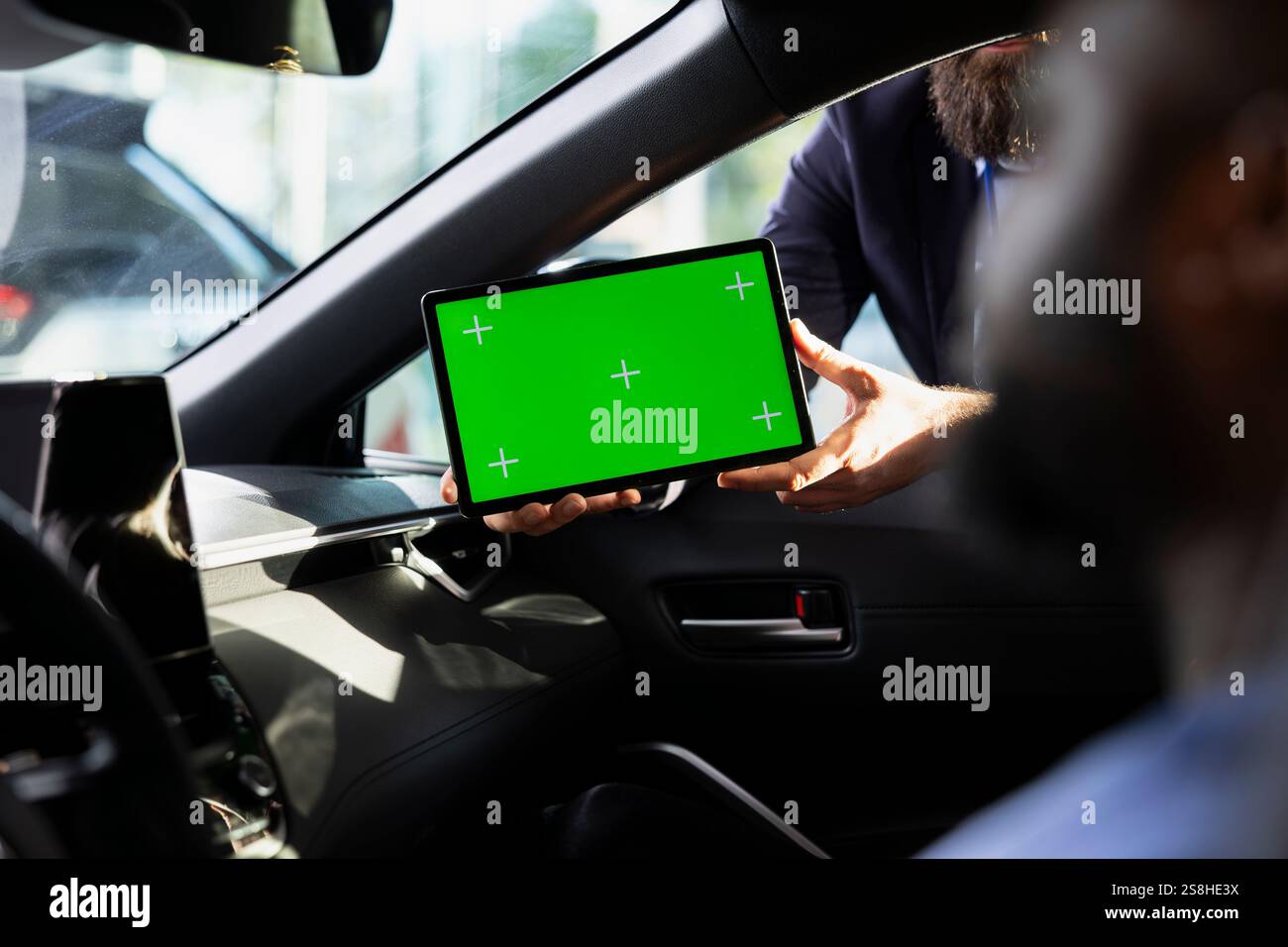 Dealership salesman showing vehicle make, model and features during ...