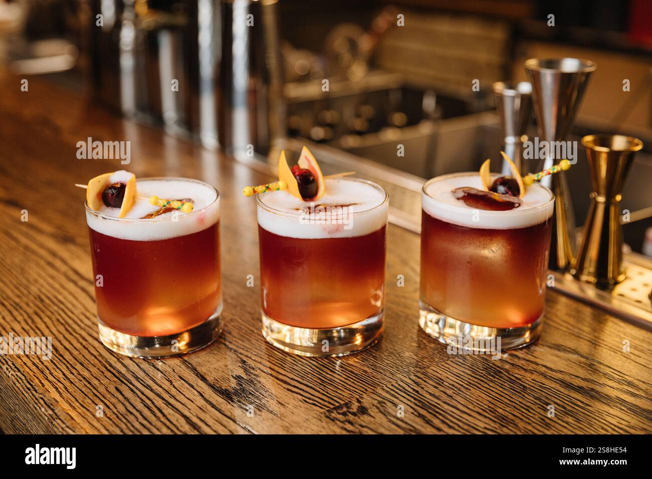 Three vibrant cocktails on a wooden bar counter, perfect for nightlife ...