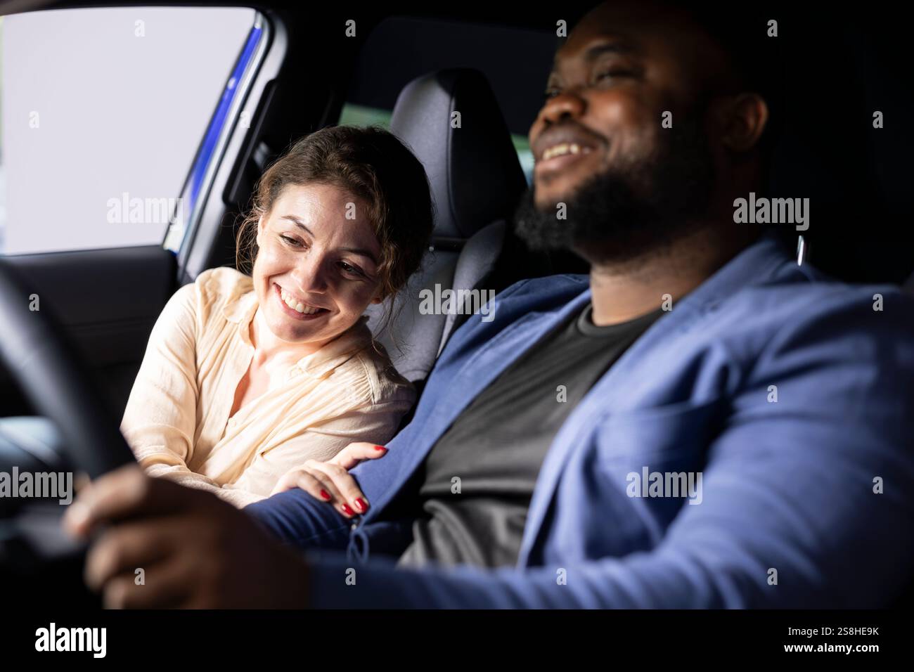 Delighted husband and wife deciding to buy car after finishing test ...