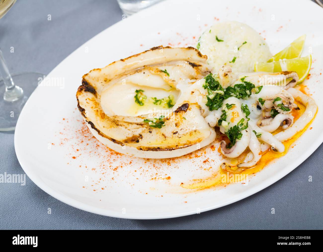 Fried cuttlefish served with rice Stock Photo - Alamy