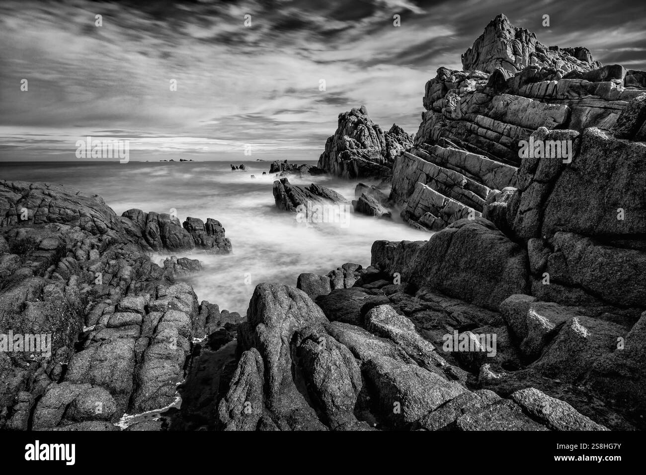 Rugged granite sea stacks and rocks, with blurred long exposure sea, on ...