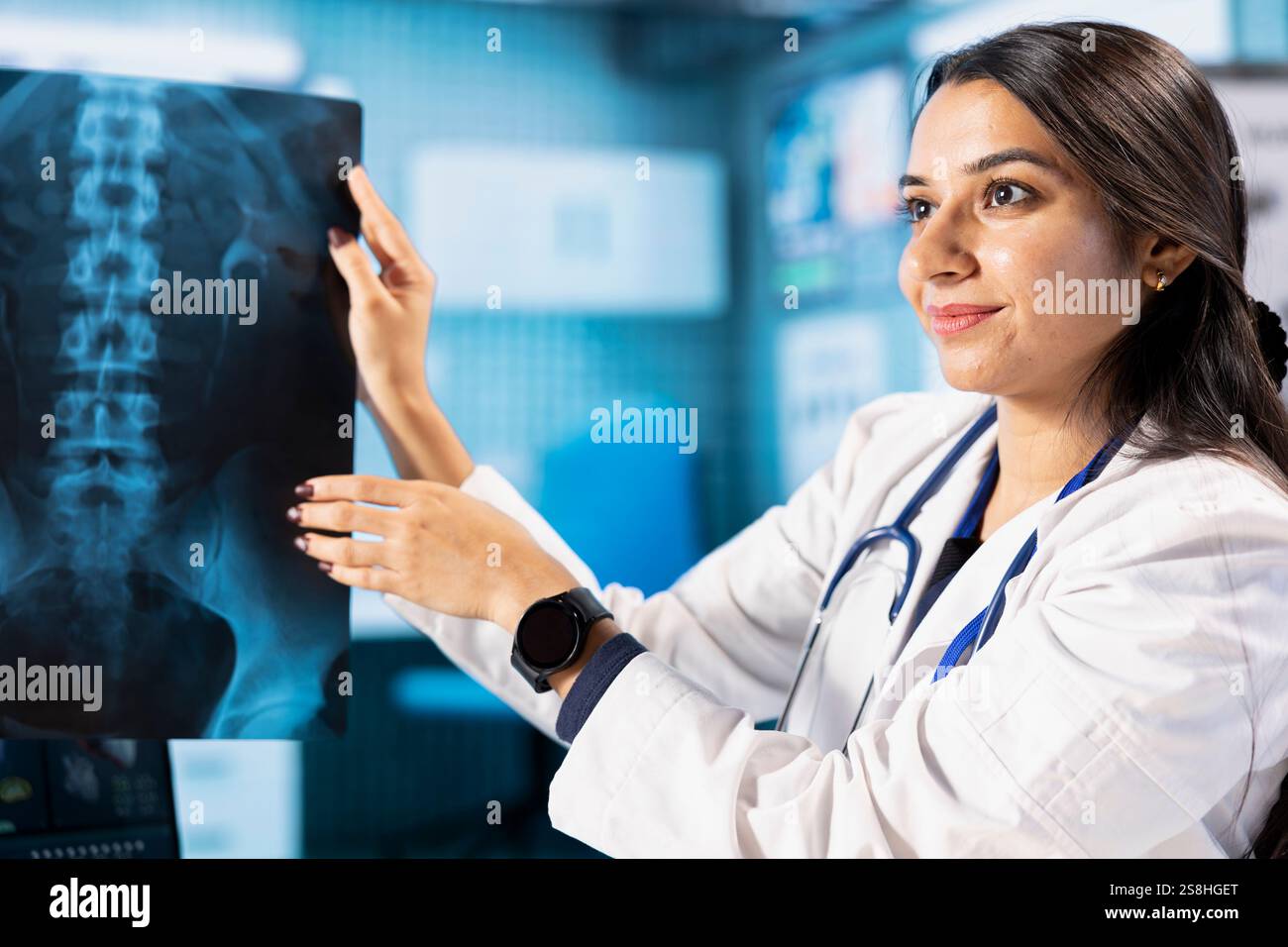 Indian healthcare expert sharing medical expertise with a patient in clinic office, reviewing x ...