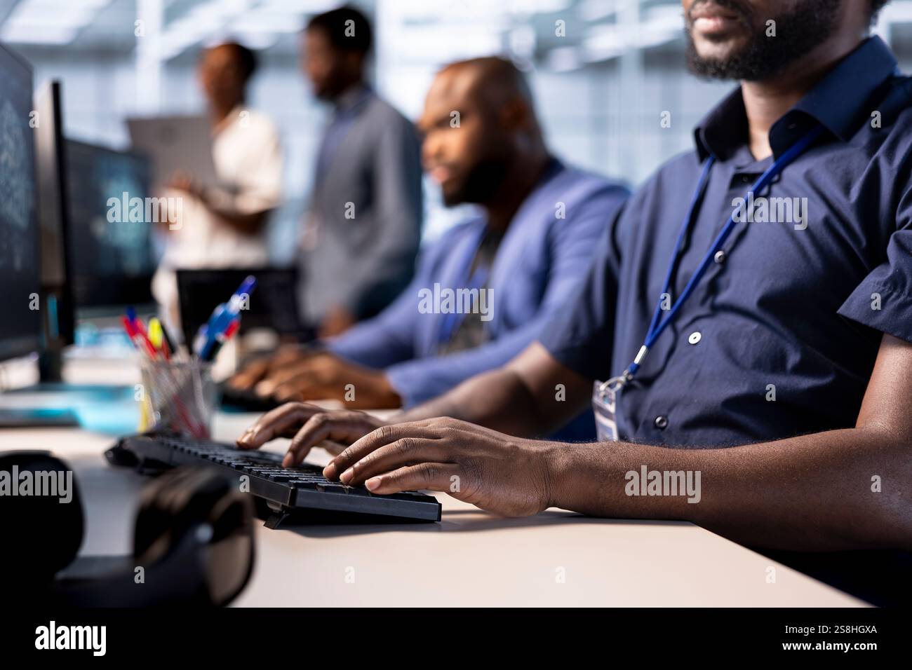 Team of developers in data center using diagnostic tools and system monitoring software to ...