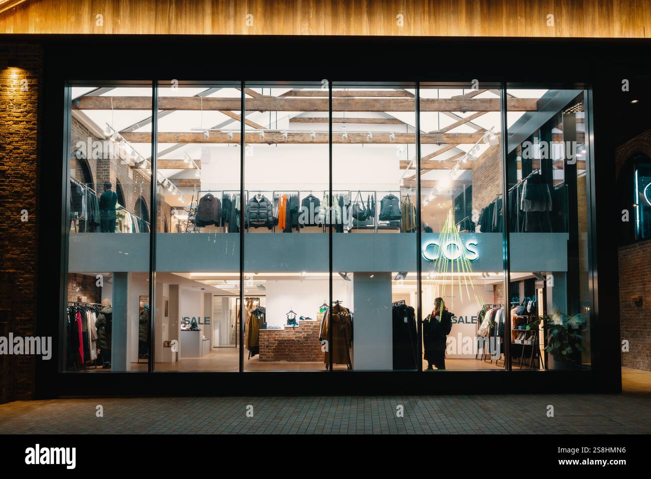 Modern Cos Storefront Display View at Night With Fashion Items and Sale ...