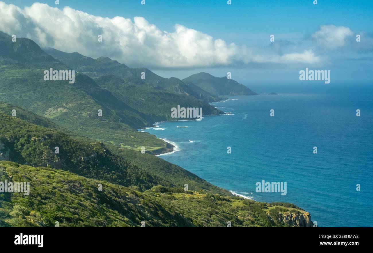 Mountainous coastal landscape by the sea, blue sky with clouds ...