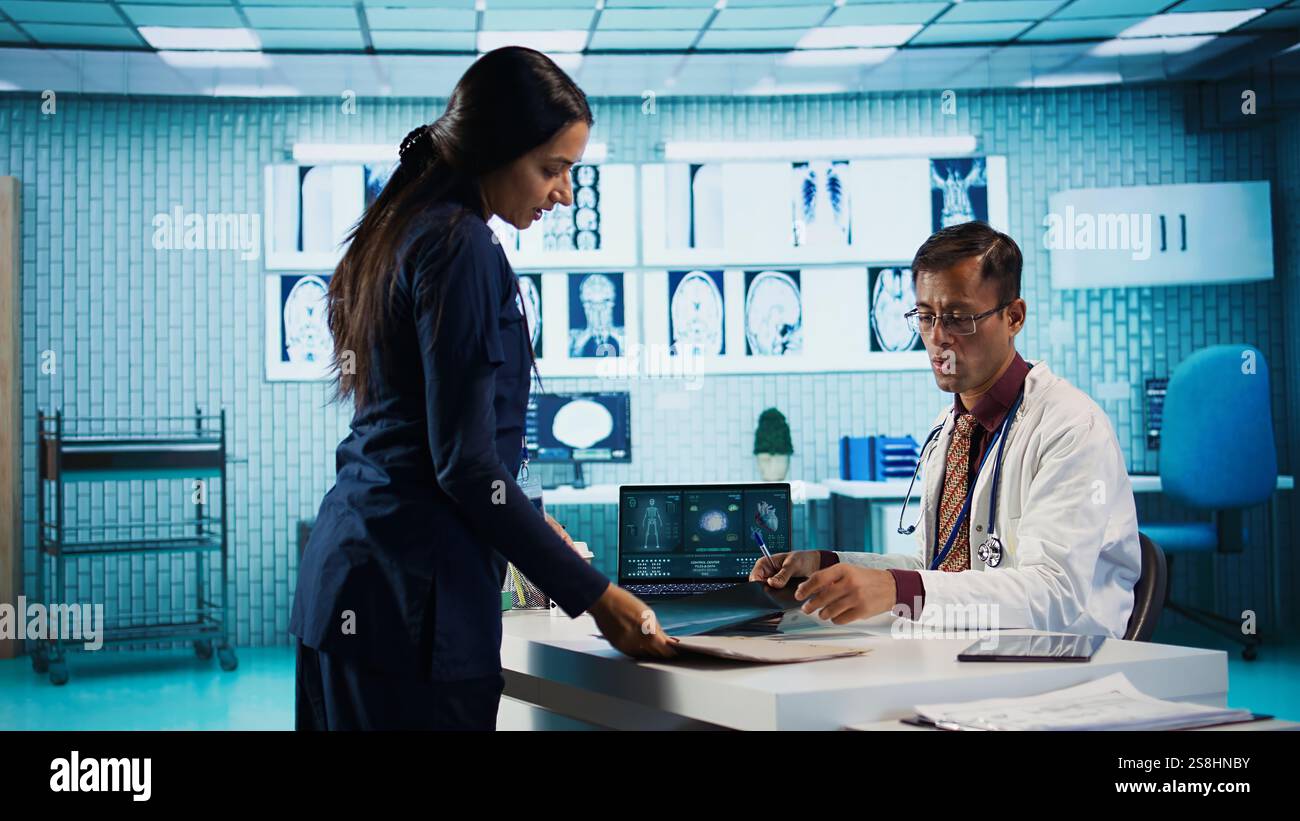 Indian general practitioner studying hospital records and x ray test ...