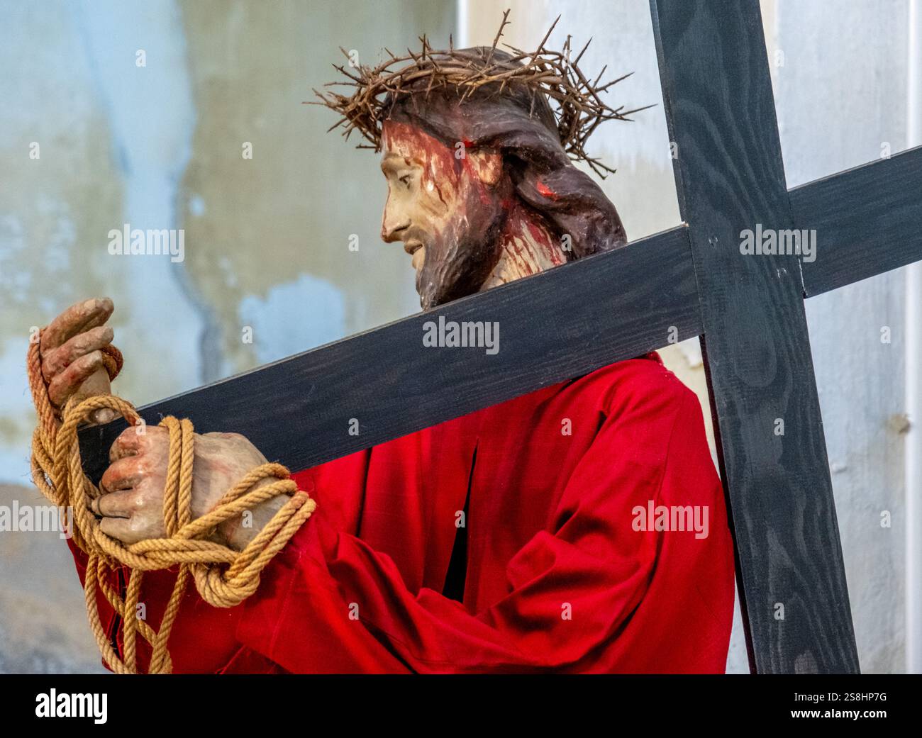 maltreated and bleeding face of Jesus with crown of thorns and wooden ...