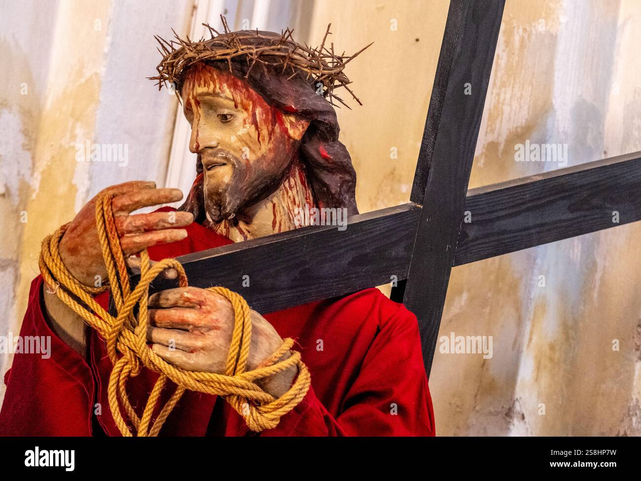 maltreated and bleeding face of Jesus with crown of thorns and wooden ...