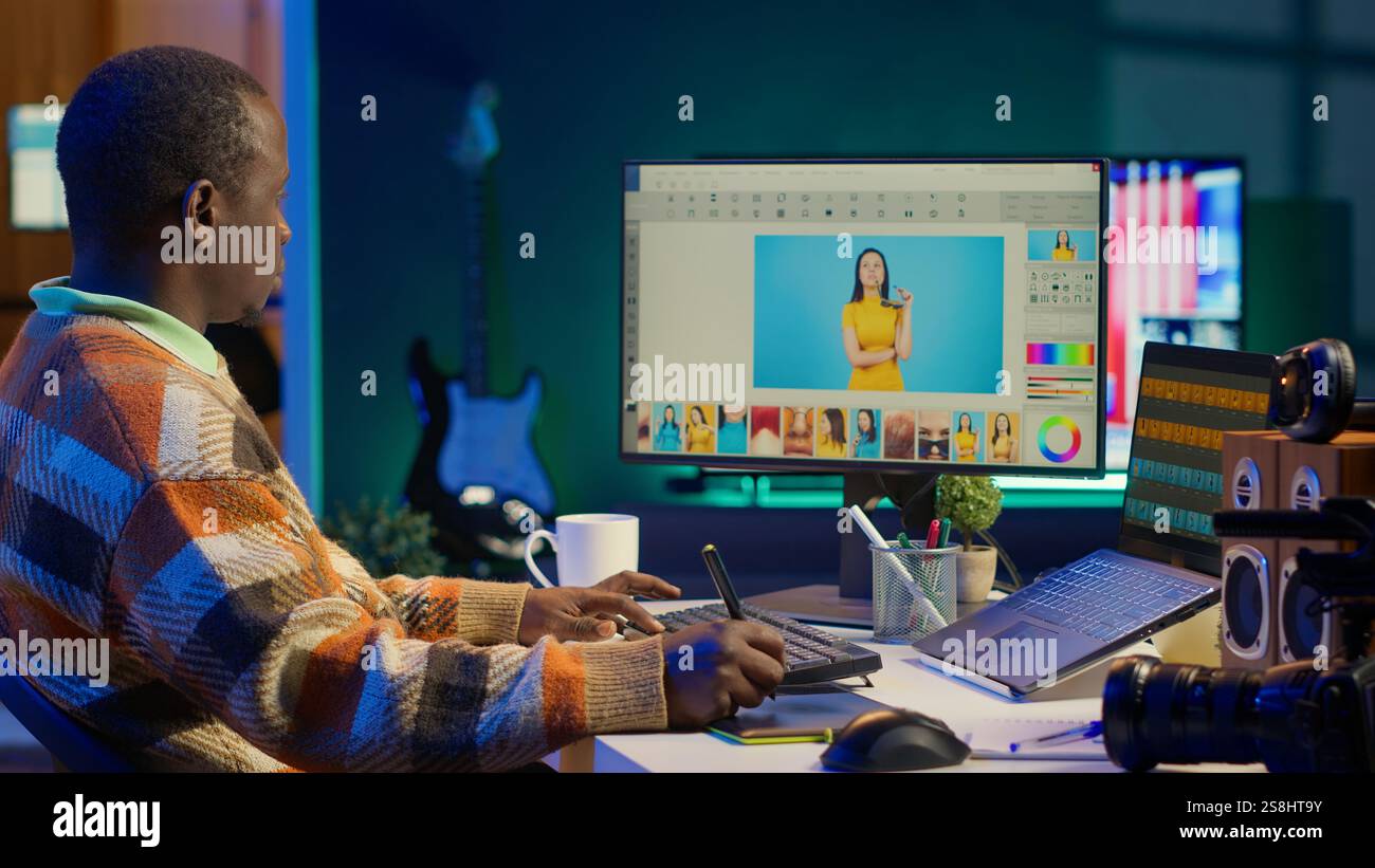 Creative african american graphic designer editing images on dual ...