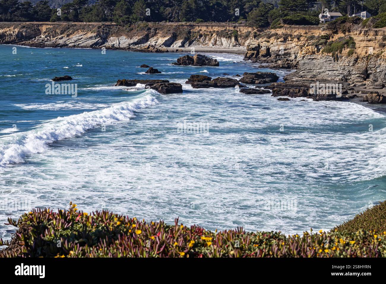 Scenic coastline view with crashing waves and rocky cliffs during a ...