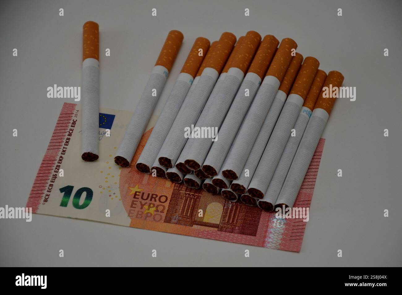 In this photo illustration, cigarettes are seen on a 10 euro banknote ...