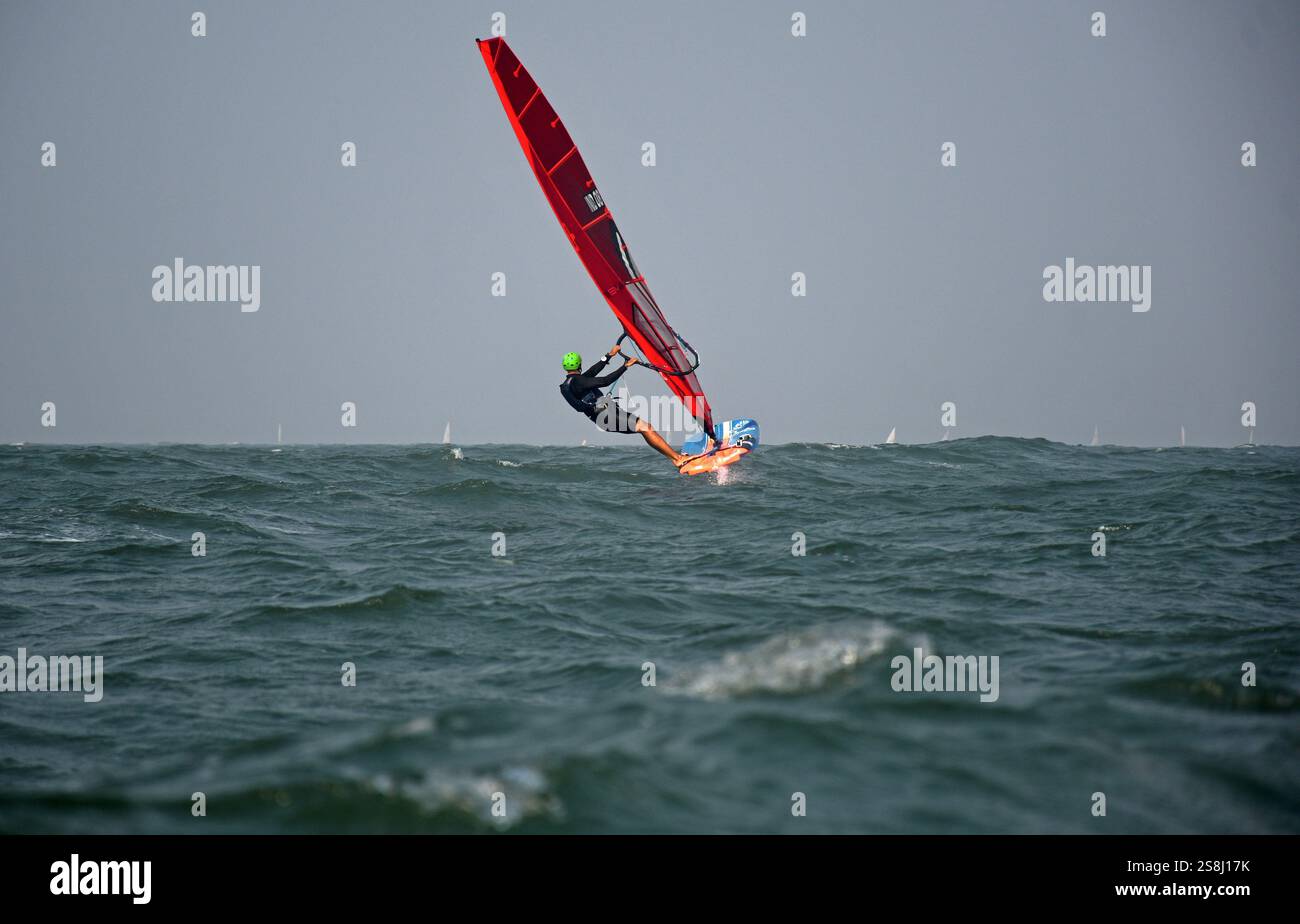 Mumbai, India. 22nd Jan, 2025. A surfer sails on the waters of Arabian ...