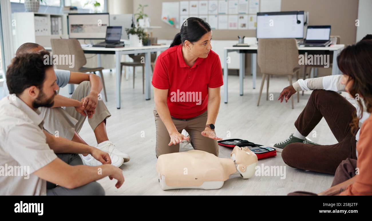 First aid, cpr training and people in office, mannequin for safety ...