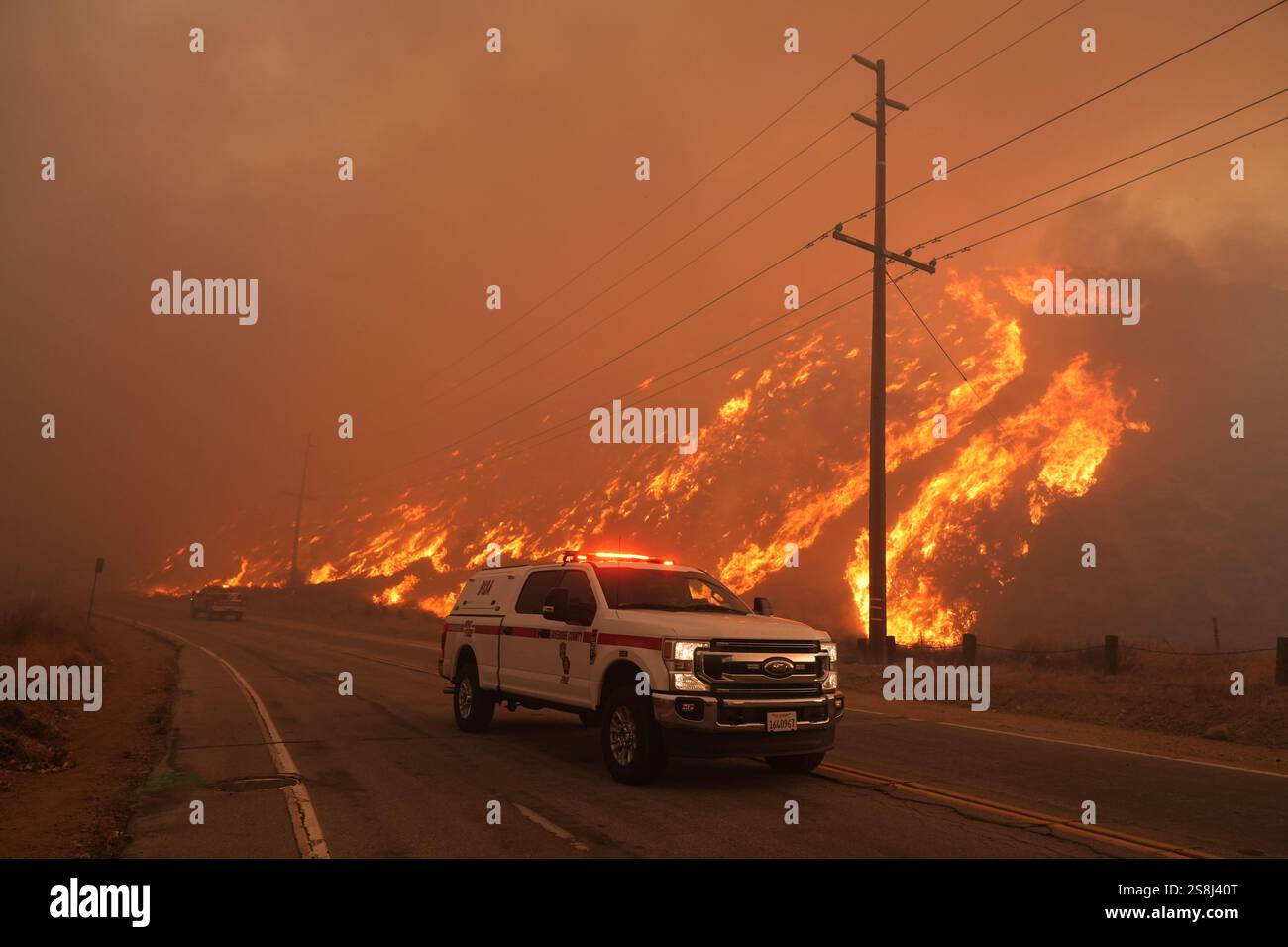 Flames caused by the Hughes Fire along Castaic Lake is seen in Castaic ...