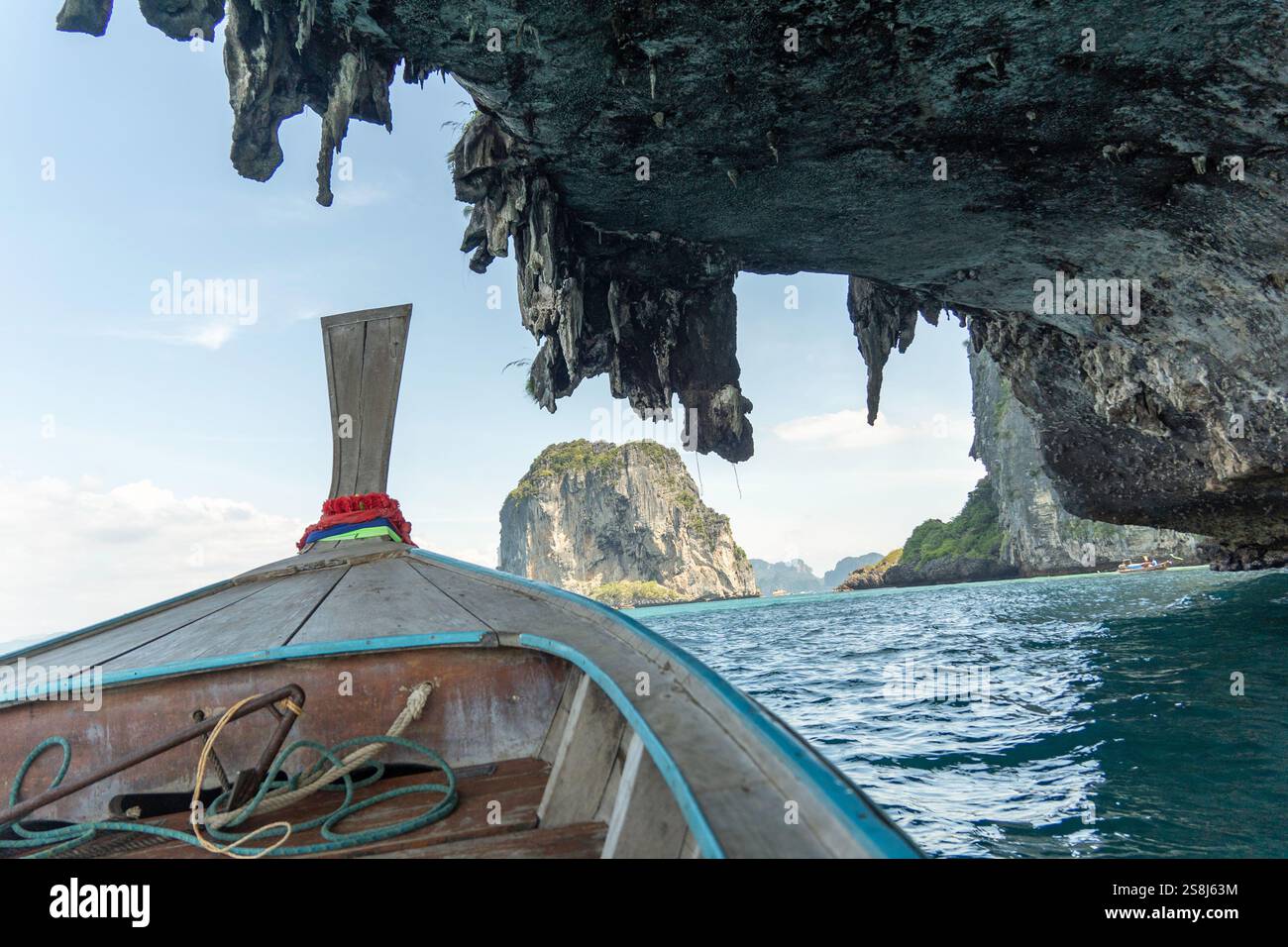 Scenic boat ride under towering limestone cliffs in Thailand's stunning ...