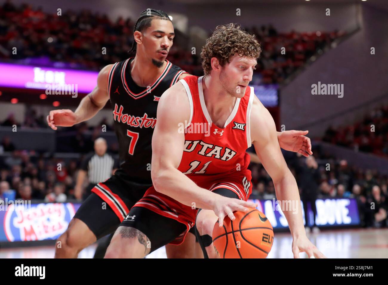 Utah forward Caleb Lohner (11) attempts to drive around Houston guard ...