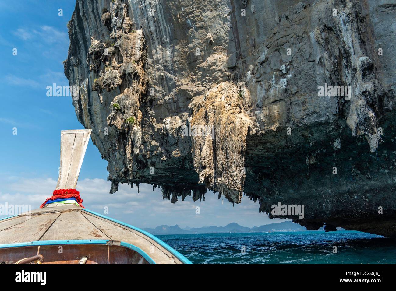 Scenic boat ride under towering limestone cliffs in Thailand's stunning ...