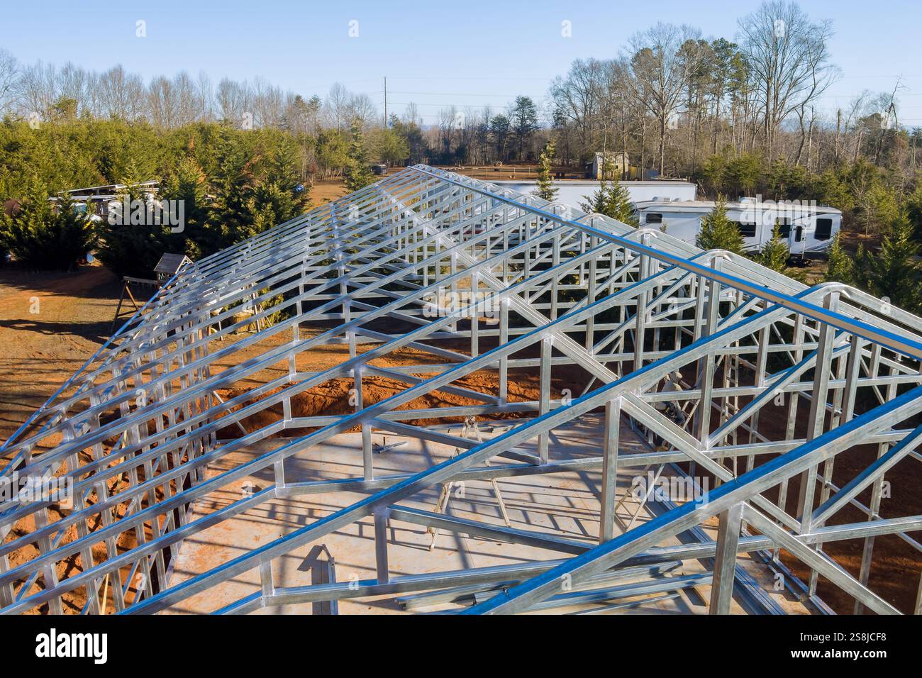 Workers construct metal beams roof framework in construction site Stock ...