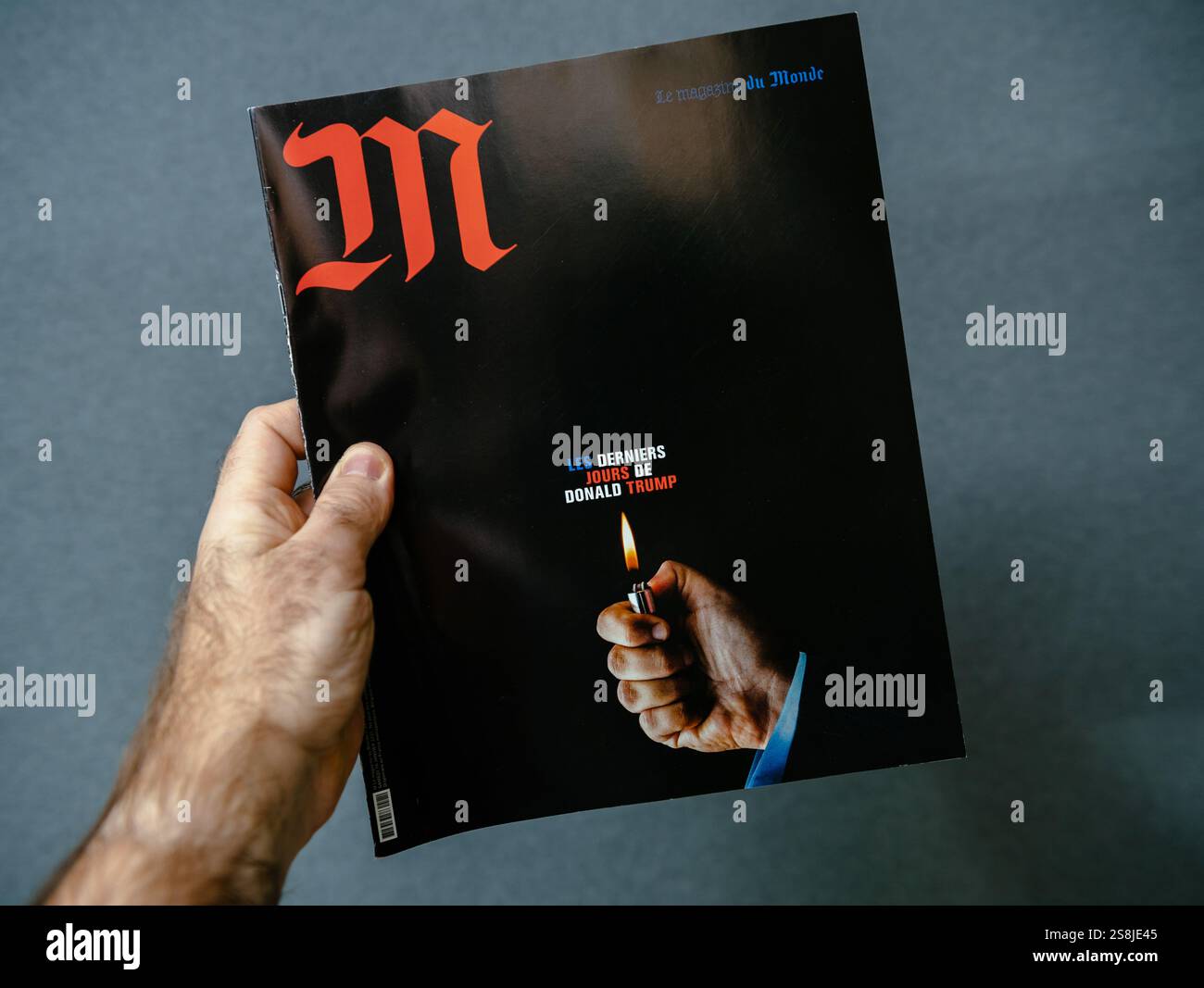 Paris, France - Jan 20, 2025: A hand holding a lighter with a flame on ...