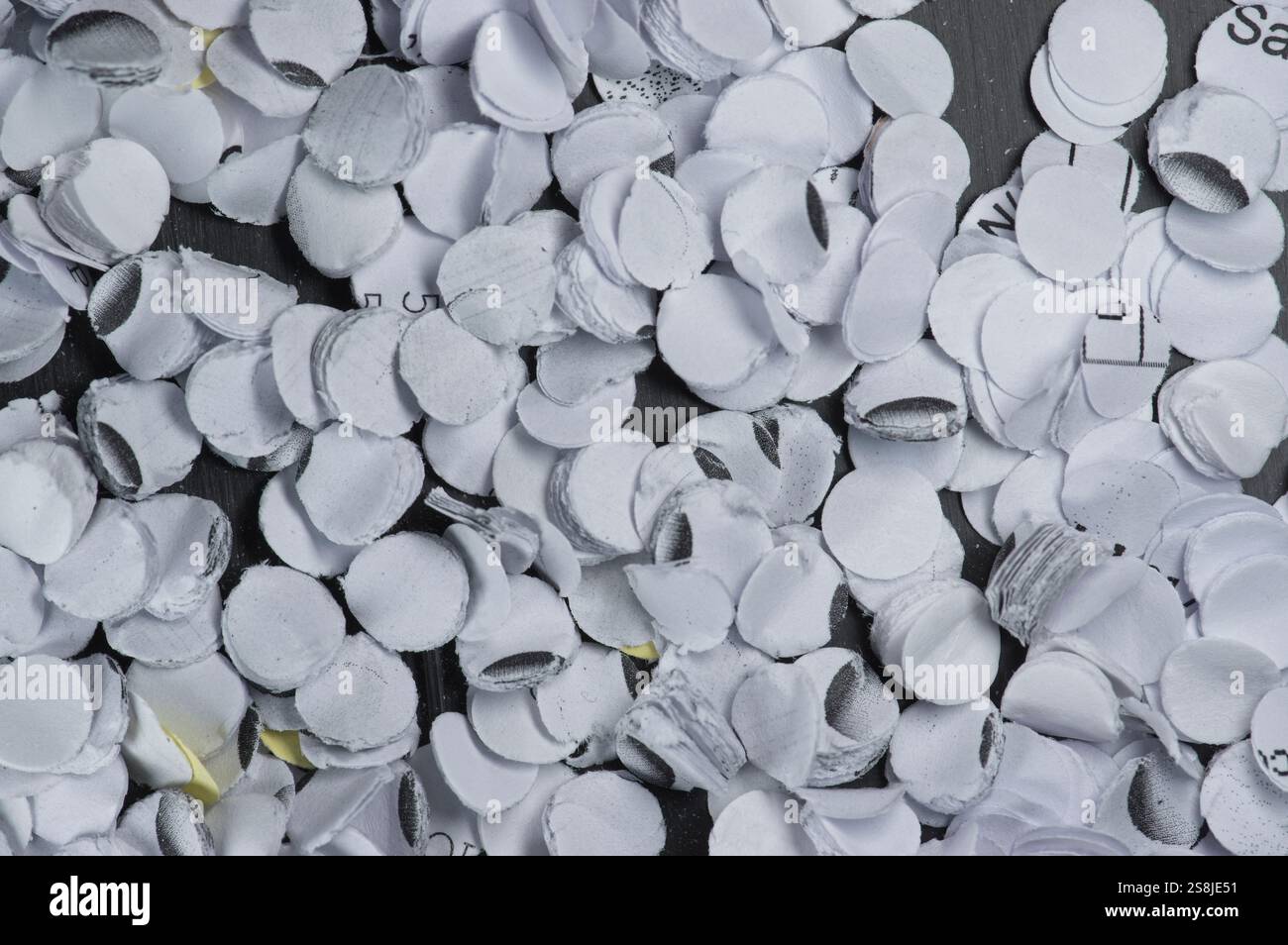 Scrap from an office hole punching machine Stock Photo - Alamy