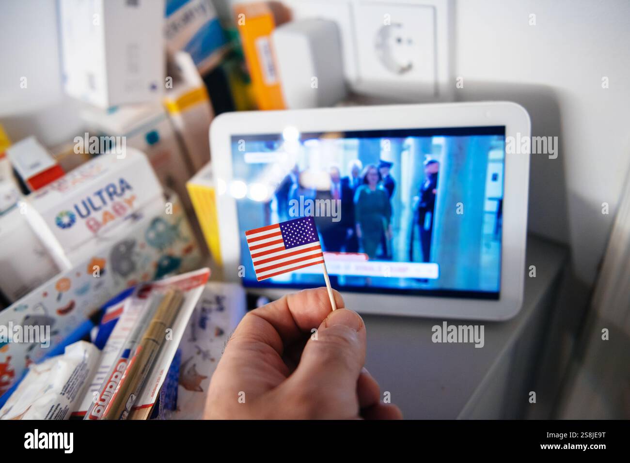 Paris, France - Jan 20, 2025: A hand holding a miniature American flag ...