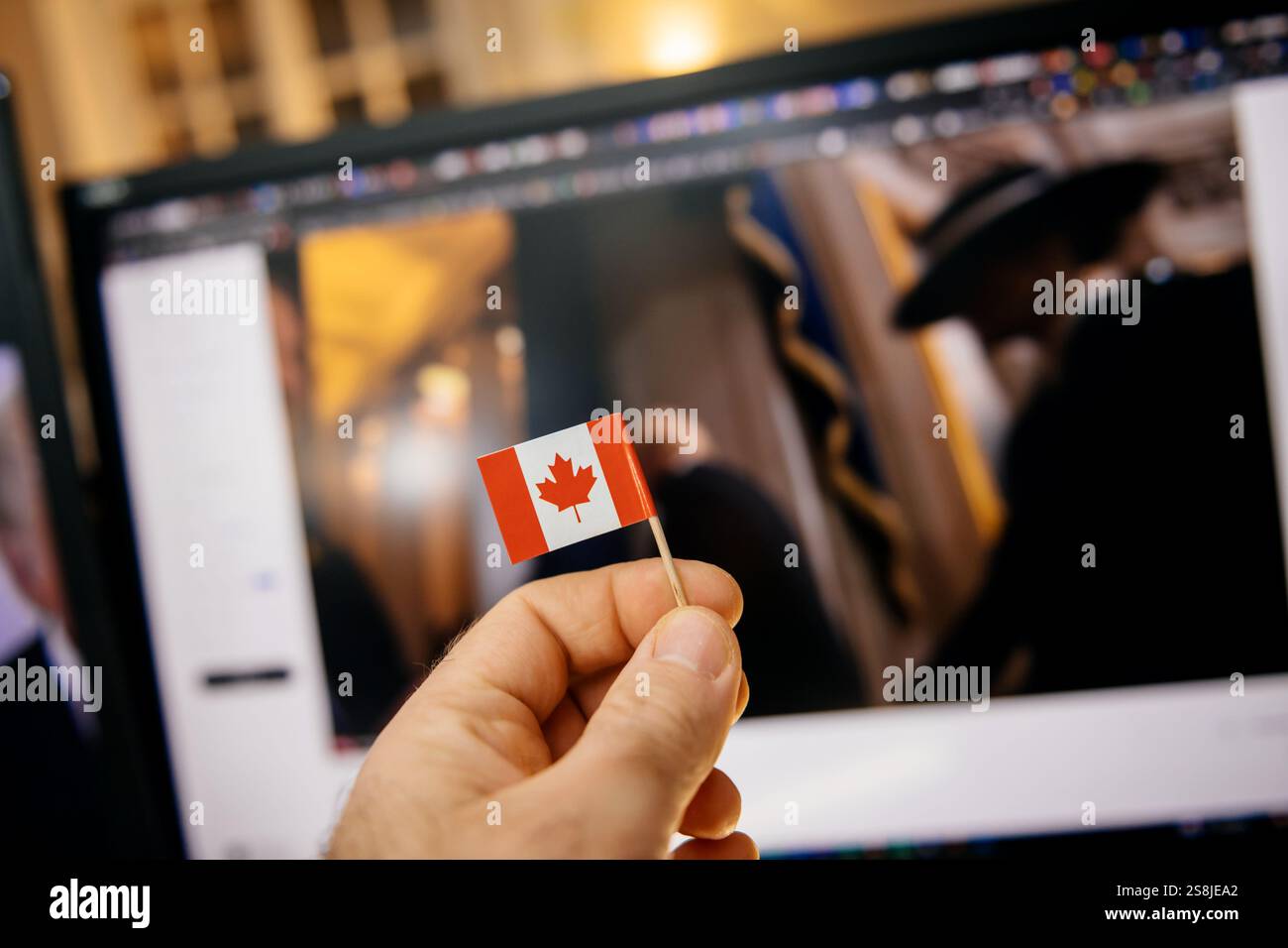 Paris, France - Jan 20, 2025: A hand holding a miniature Canadian flag ...