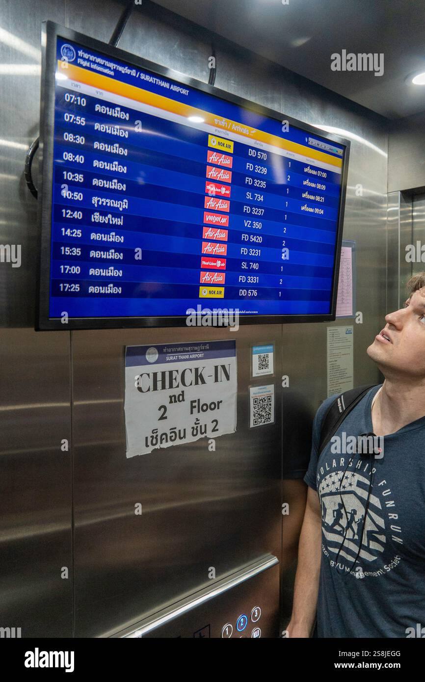 Bangkok, thailand - Dec 25 2024: Individual checks flight information ...