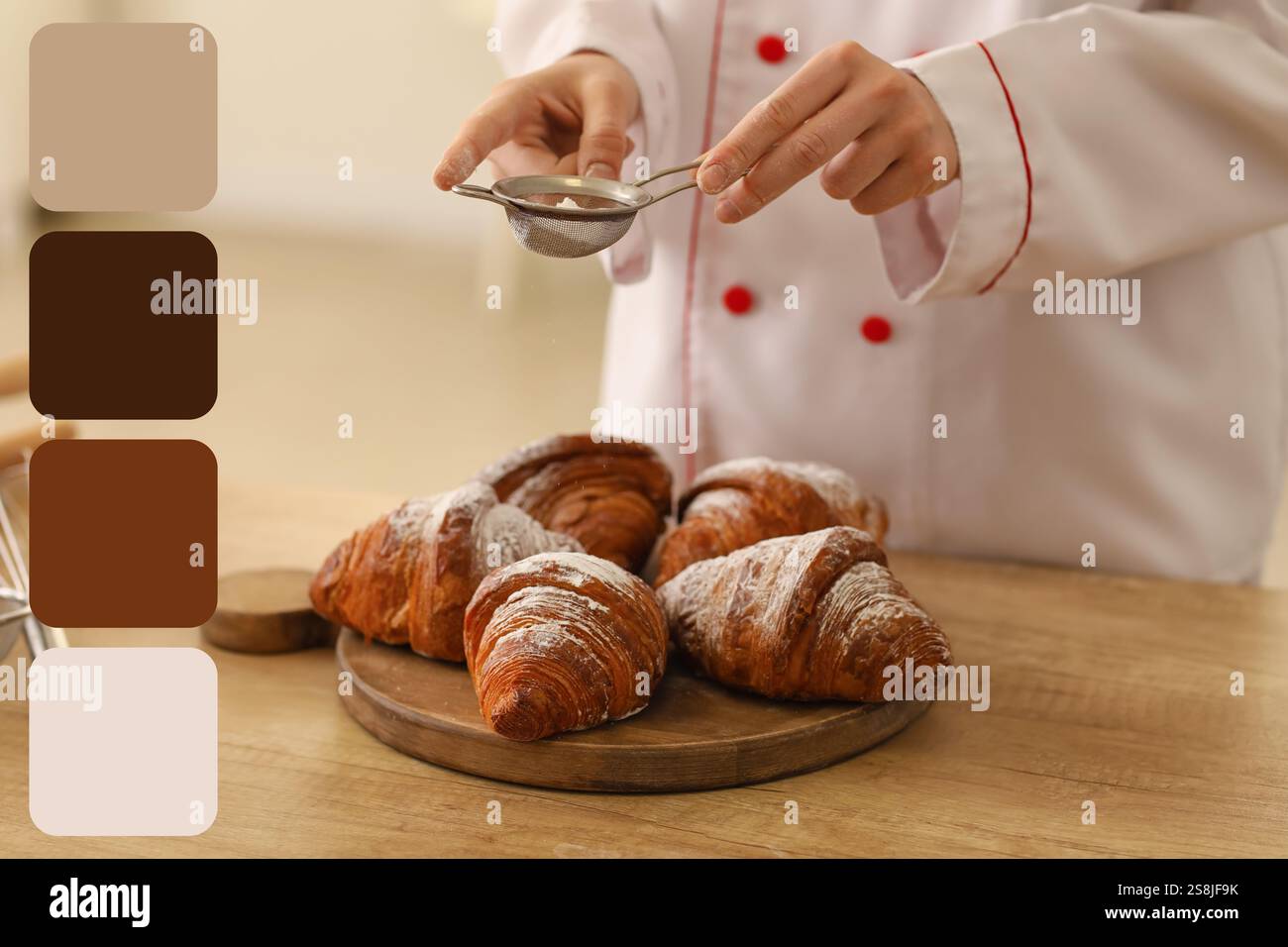 Female baker sprinkling croissants with sugar powder at table in ...