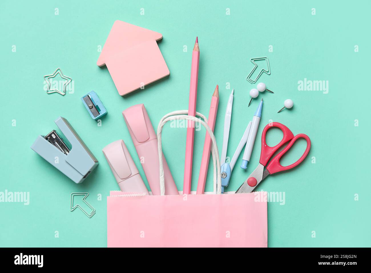 Composition with paper bag and stationery on color background Stock ...