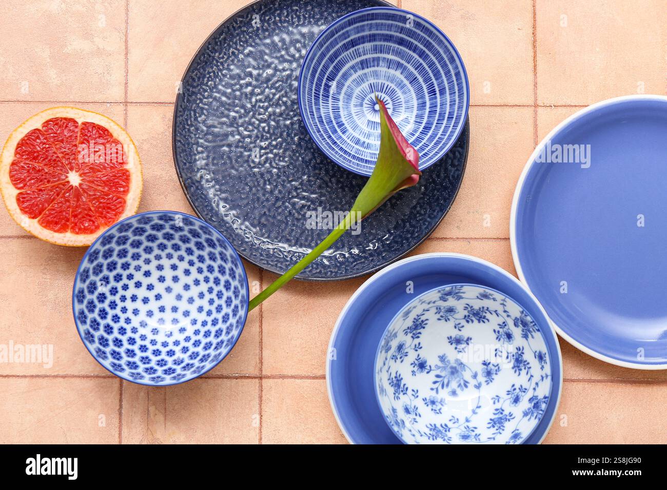 Beautiful table setting with blue ceramic plates and grapefruit on ...