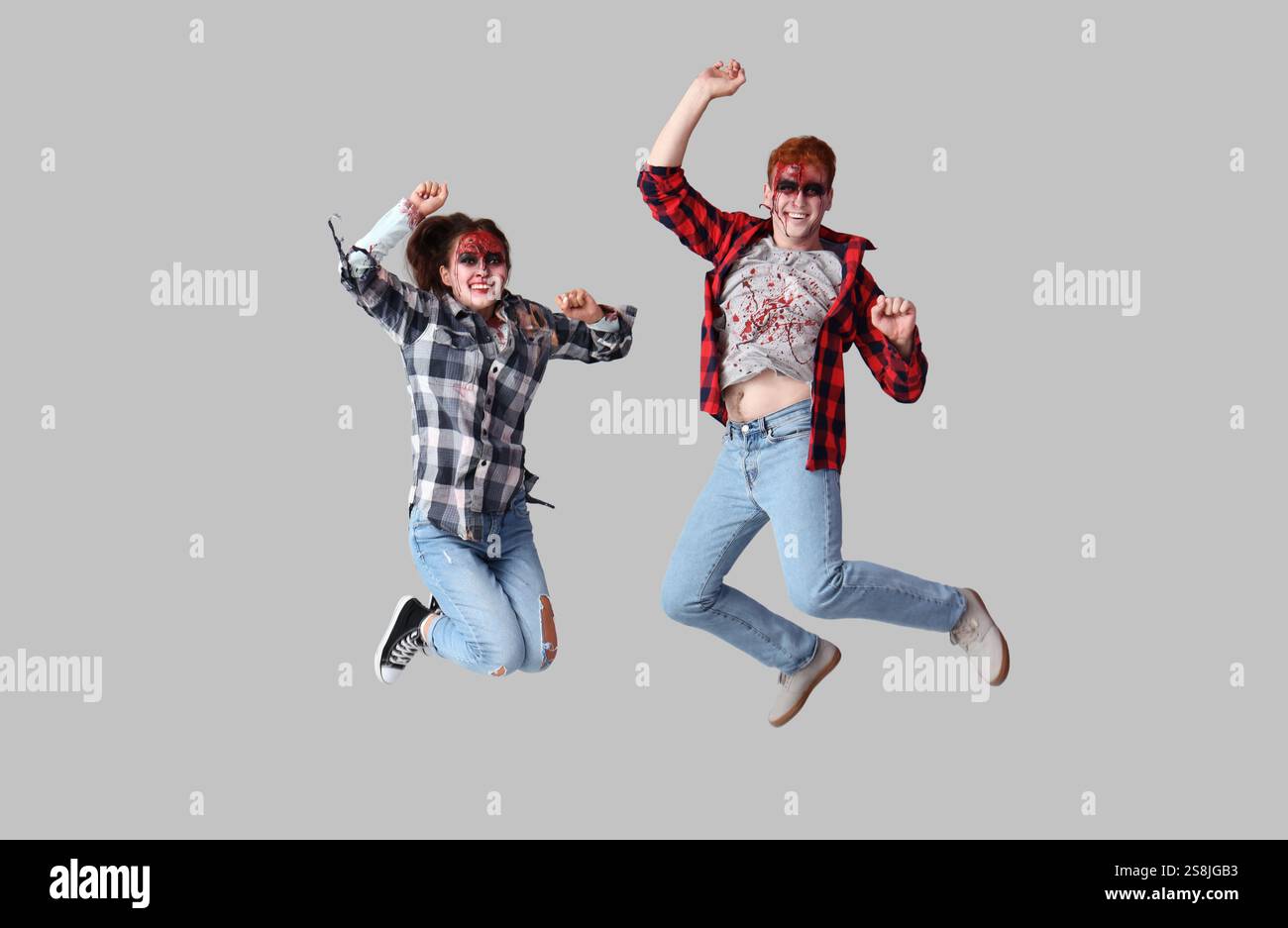 Scary zombies jumping on grey background Stock Photo - Alamy
